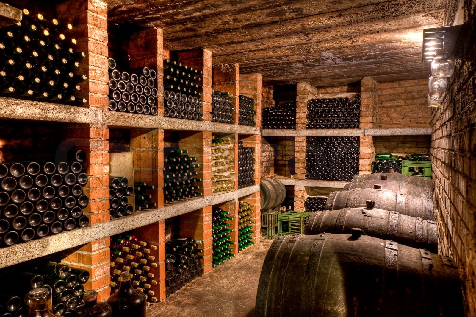 stacked up wine bottles in the cellar | Stock image | Colourbox