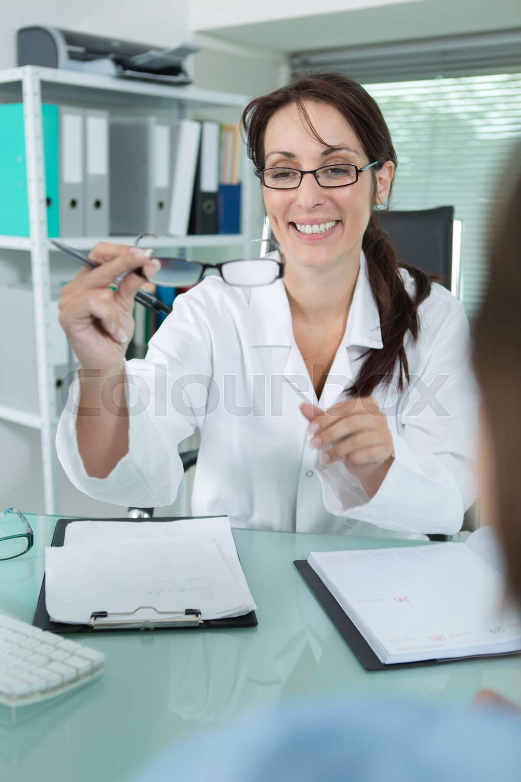 inspecting the eyeglasses lens | Stock image | Colourbox