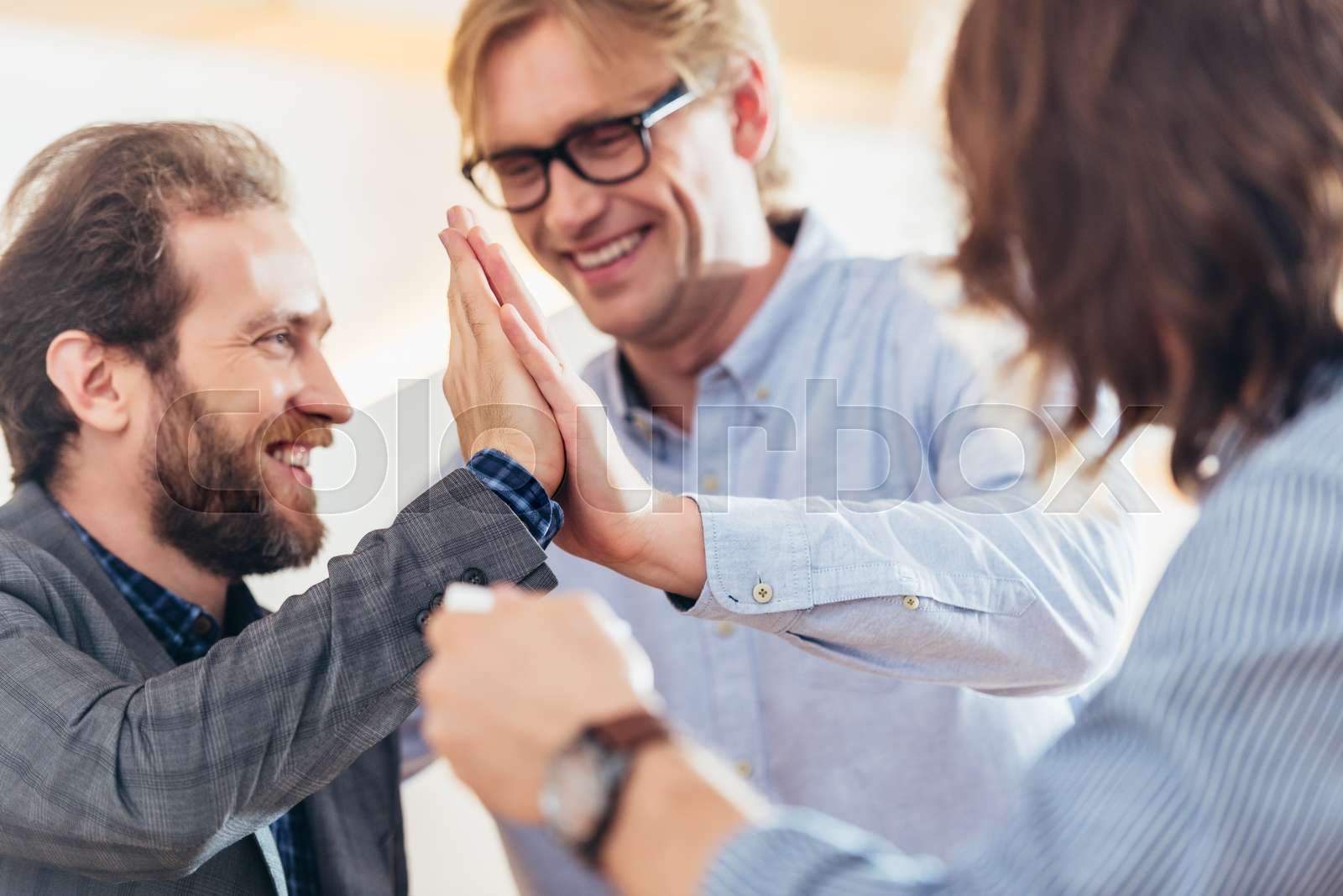 smiling men giving high five | Stock image | Colourbox