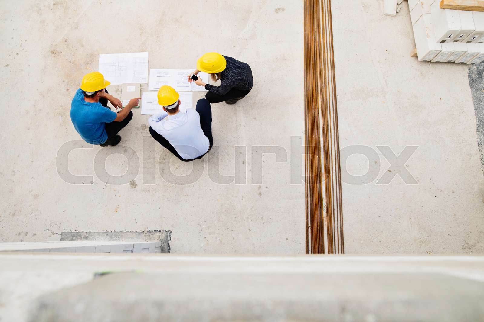Architects and worker at the construction site. | Stock image | Colourbox