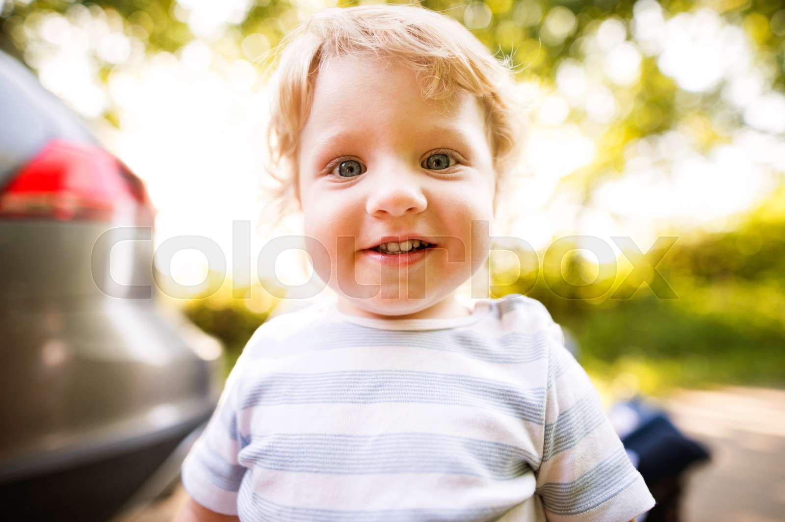 Little boy standing by the car. | Stock image | Colourbox