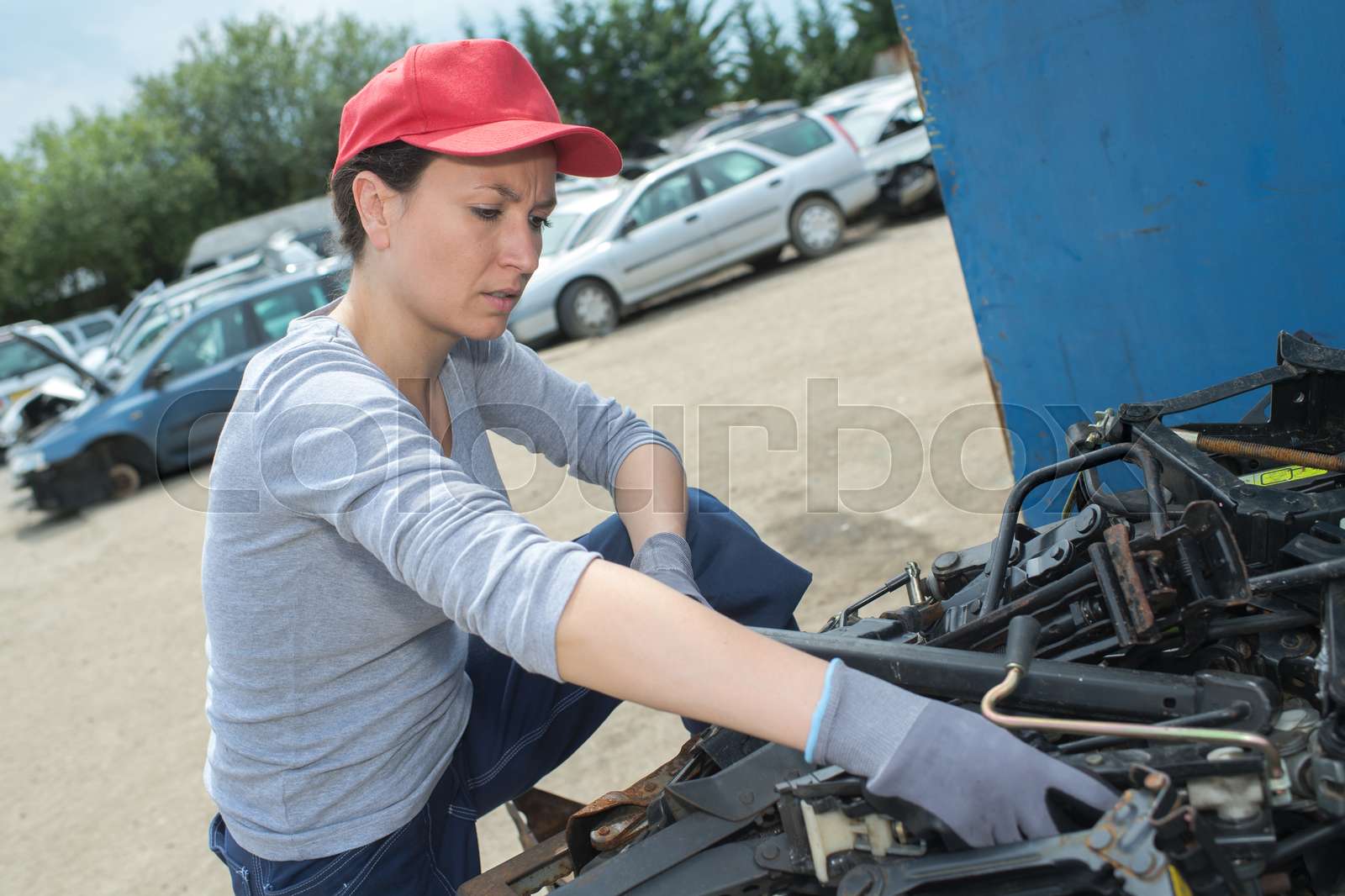 a beautiful young woman trying to repair the car | Stock image | Colourbox
