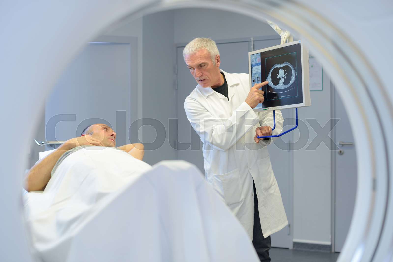 doctor looking at patient undergoing ct scan | Stock image | Colourbox