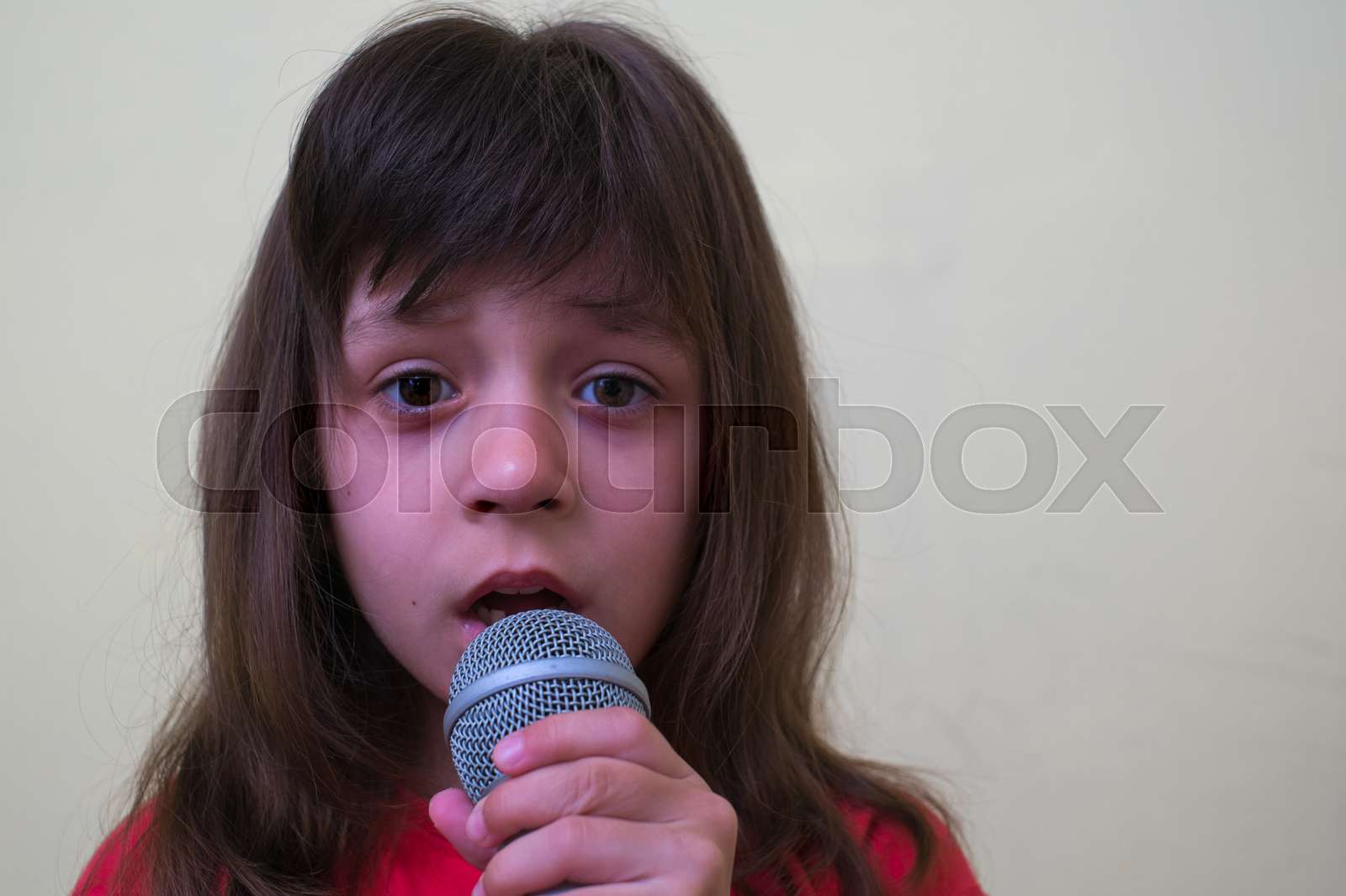 Girl with a microphone. little girl with a microphone. cute little girl ...