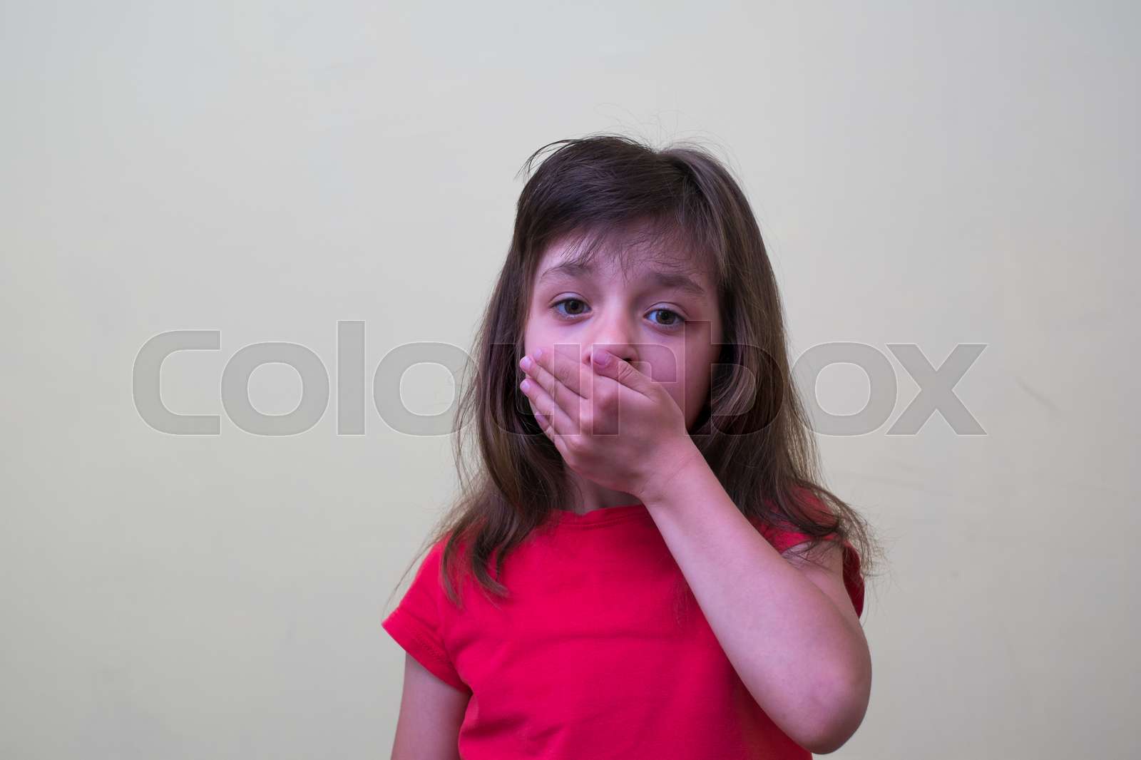 Girl child Hands closed mouth | Stock image | Colourbox