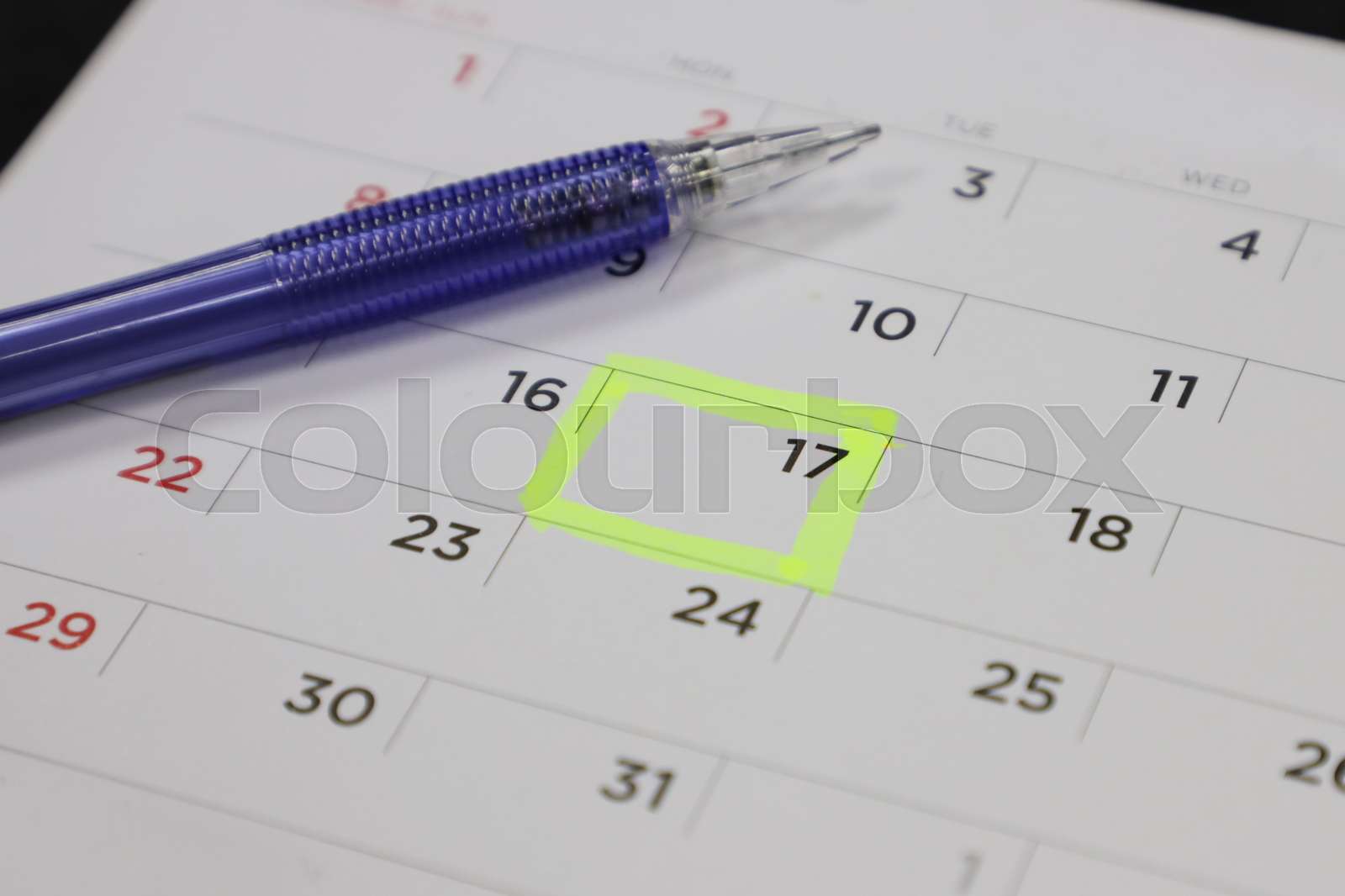 highlighter with a circled day on calendar | Stock image | Colourbox