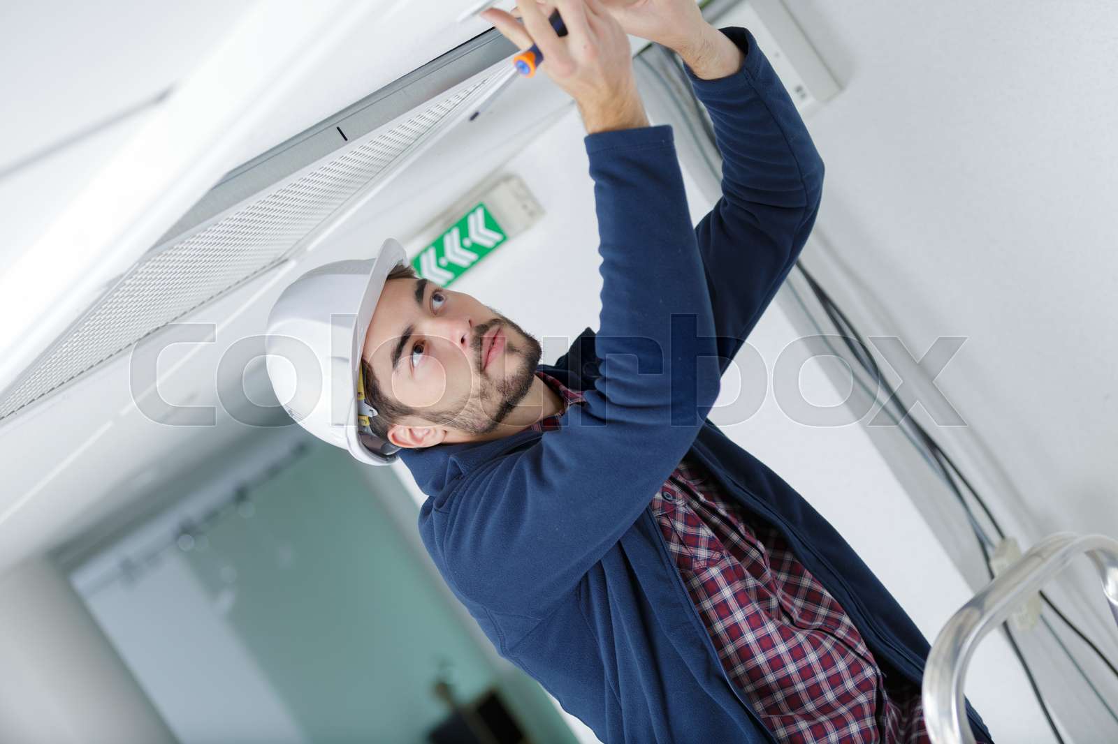 man fixing light at home | Stock image | Colourbox