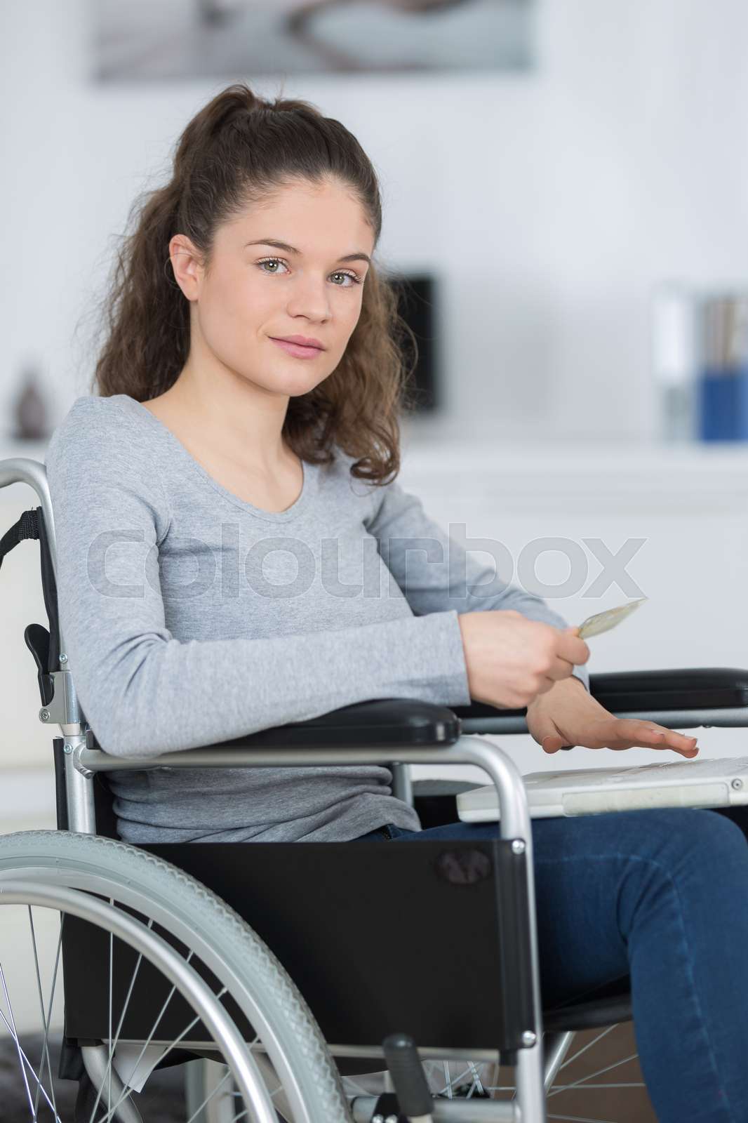 disabled woman in wheelchair with laptop | Stock image | Colourbox