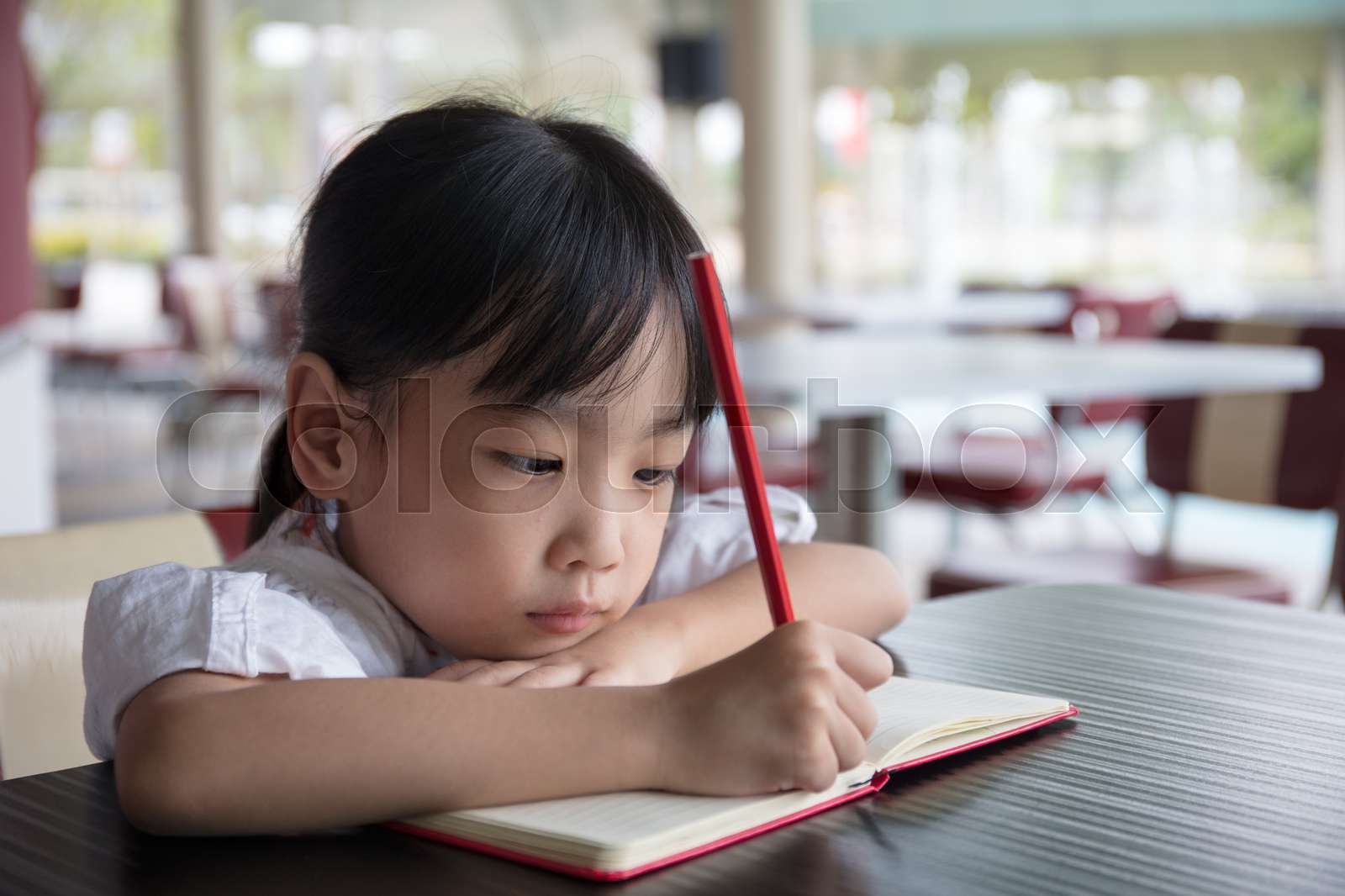 Asian Chinese little girl doing homework | Stock image | Colourbox
