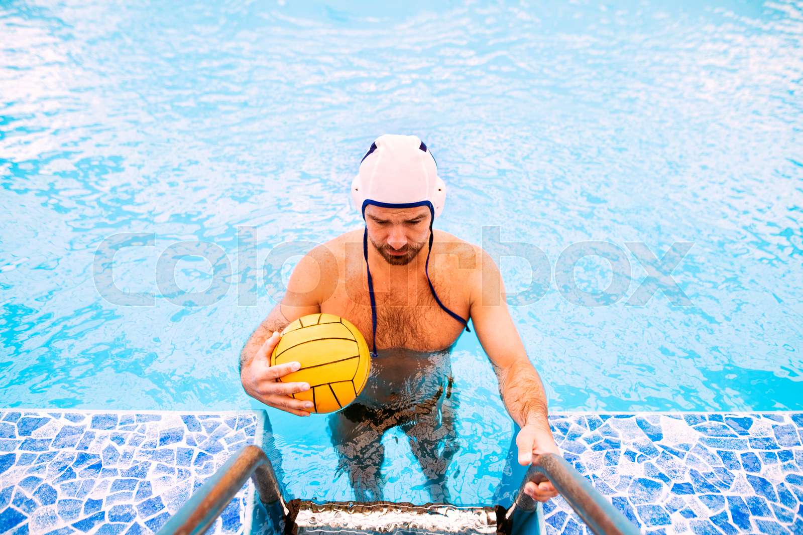 Water polo player in a swimming pool. | Stock image | Colourbox