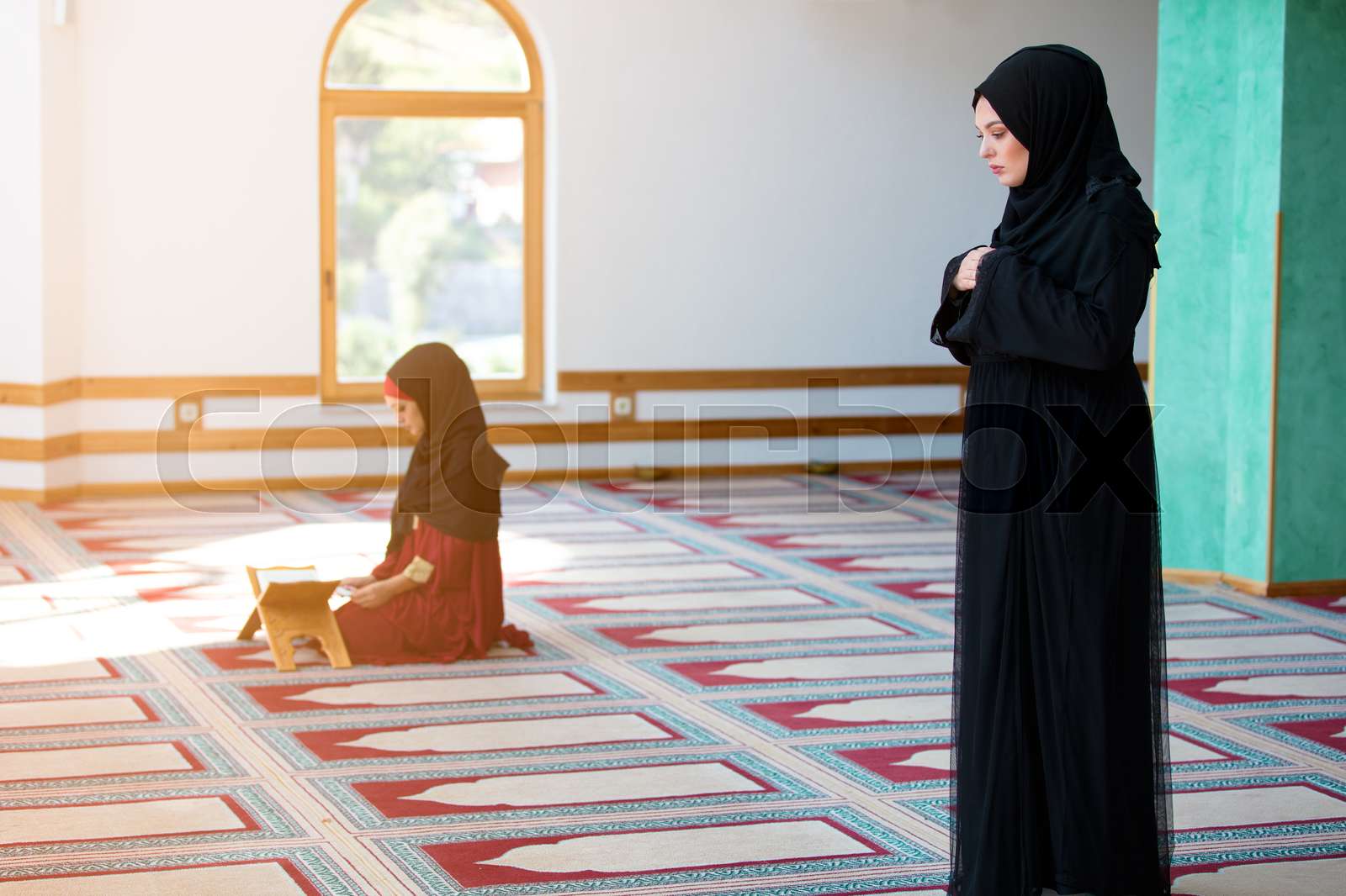 Two Muslim women praying | Stock image | Colourbox