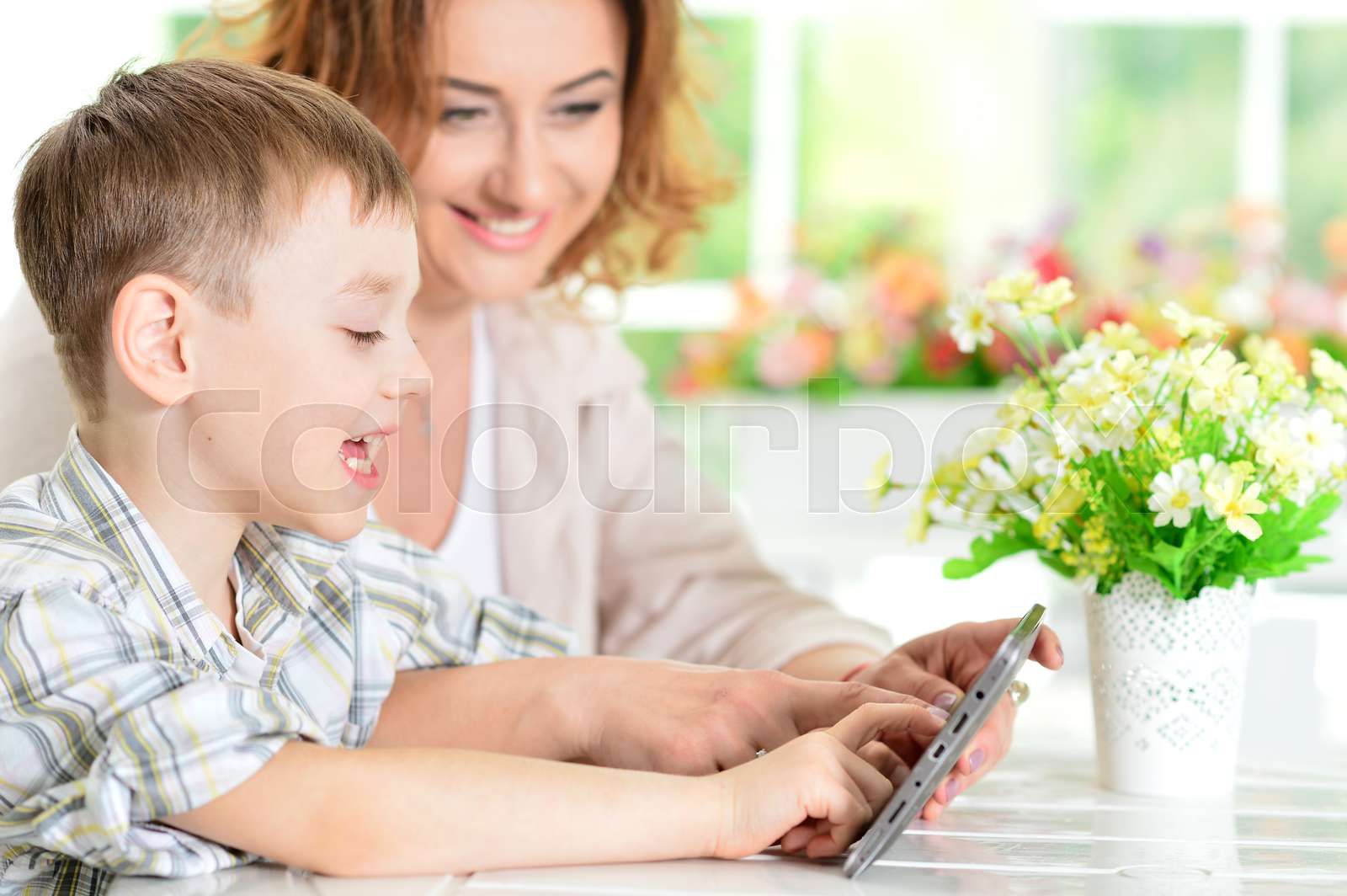 Mother And Son Using Smartphone Stock Image Colourbox