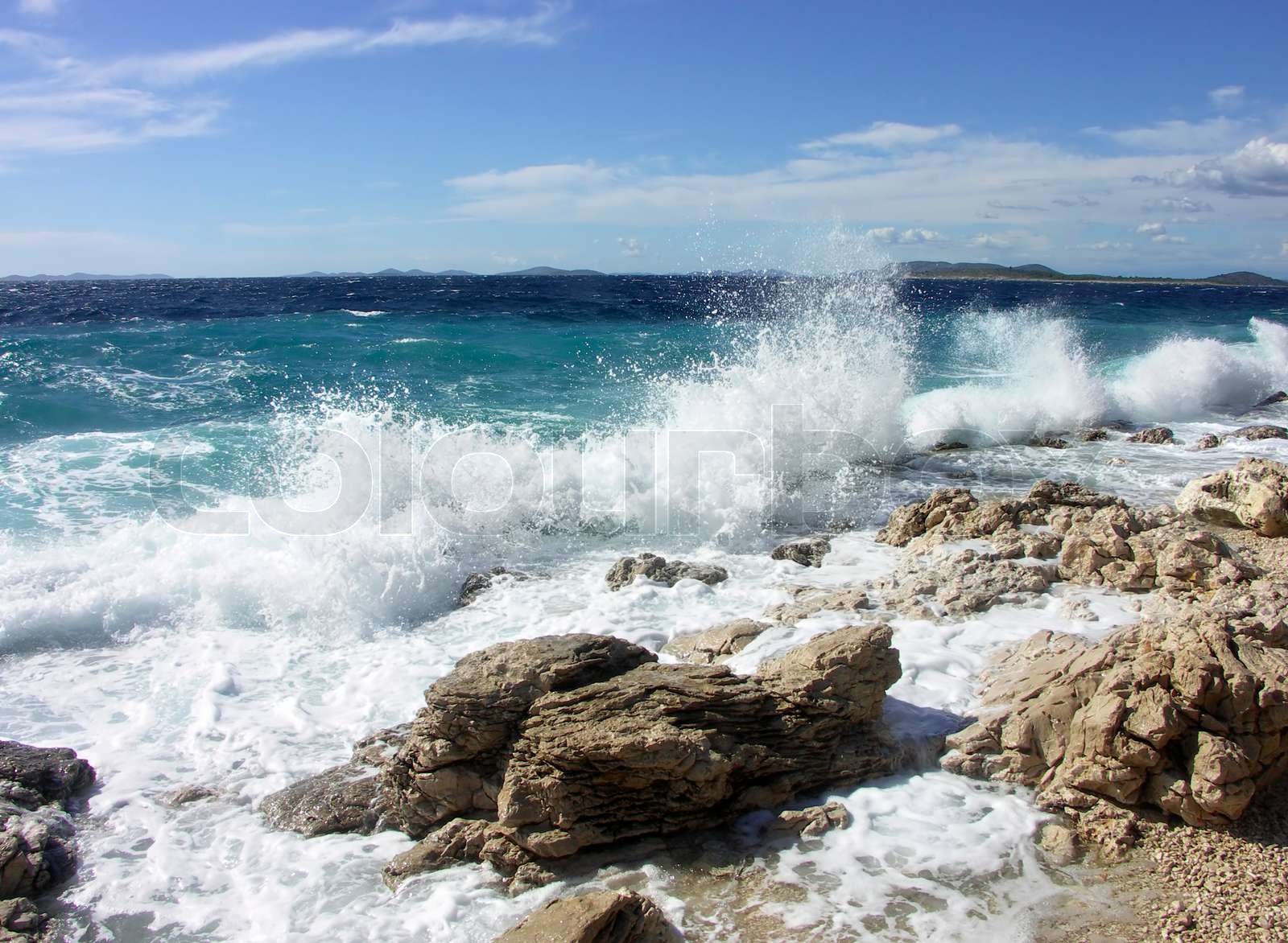Impact of large waves against rocks in the beach | Stock image | Colourbox