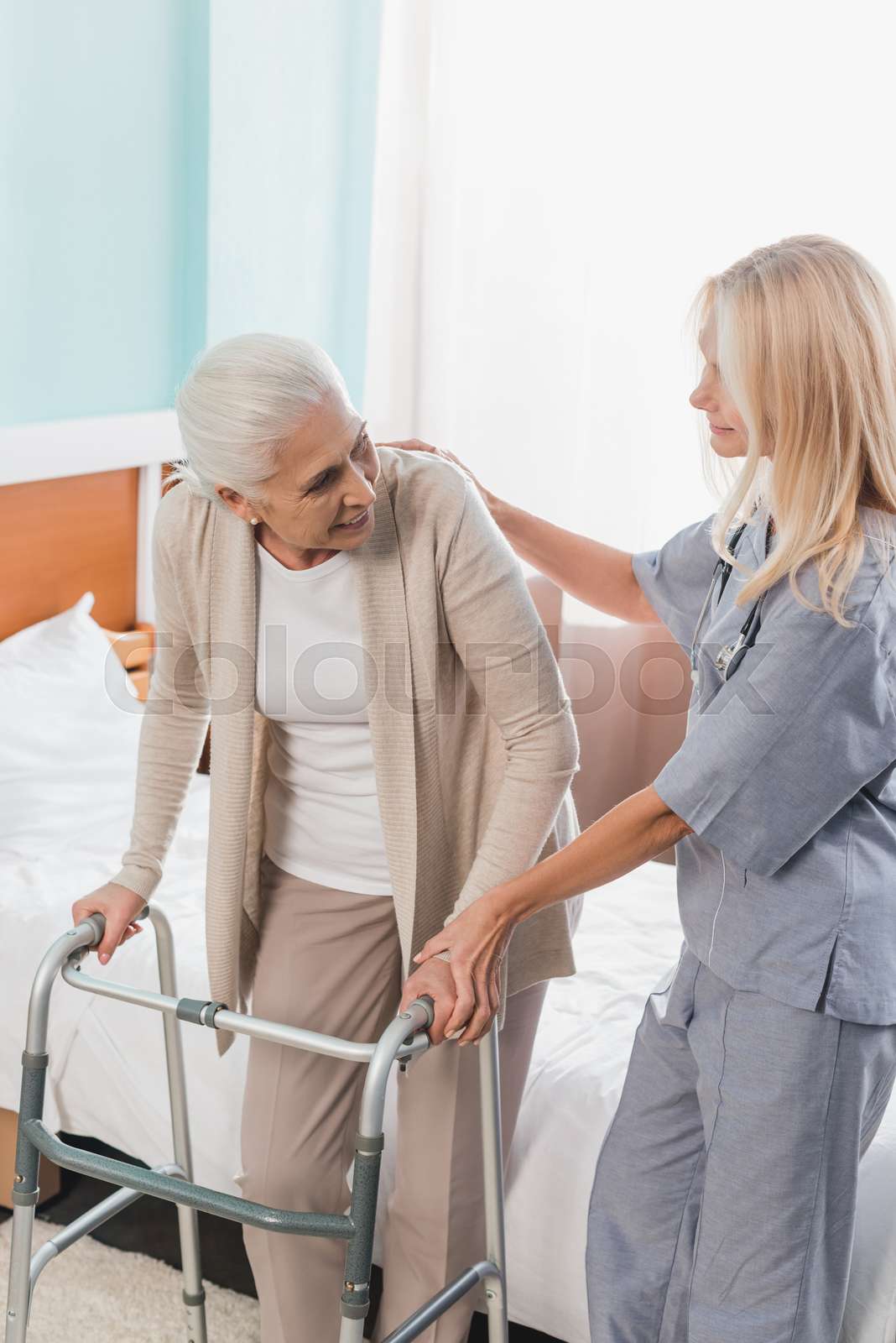 nurse and senior patient with walker | Stock image | Colourbox