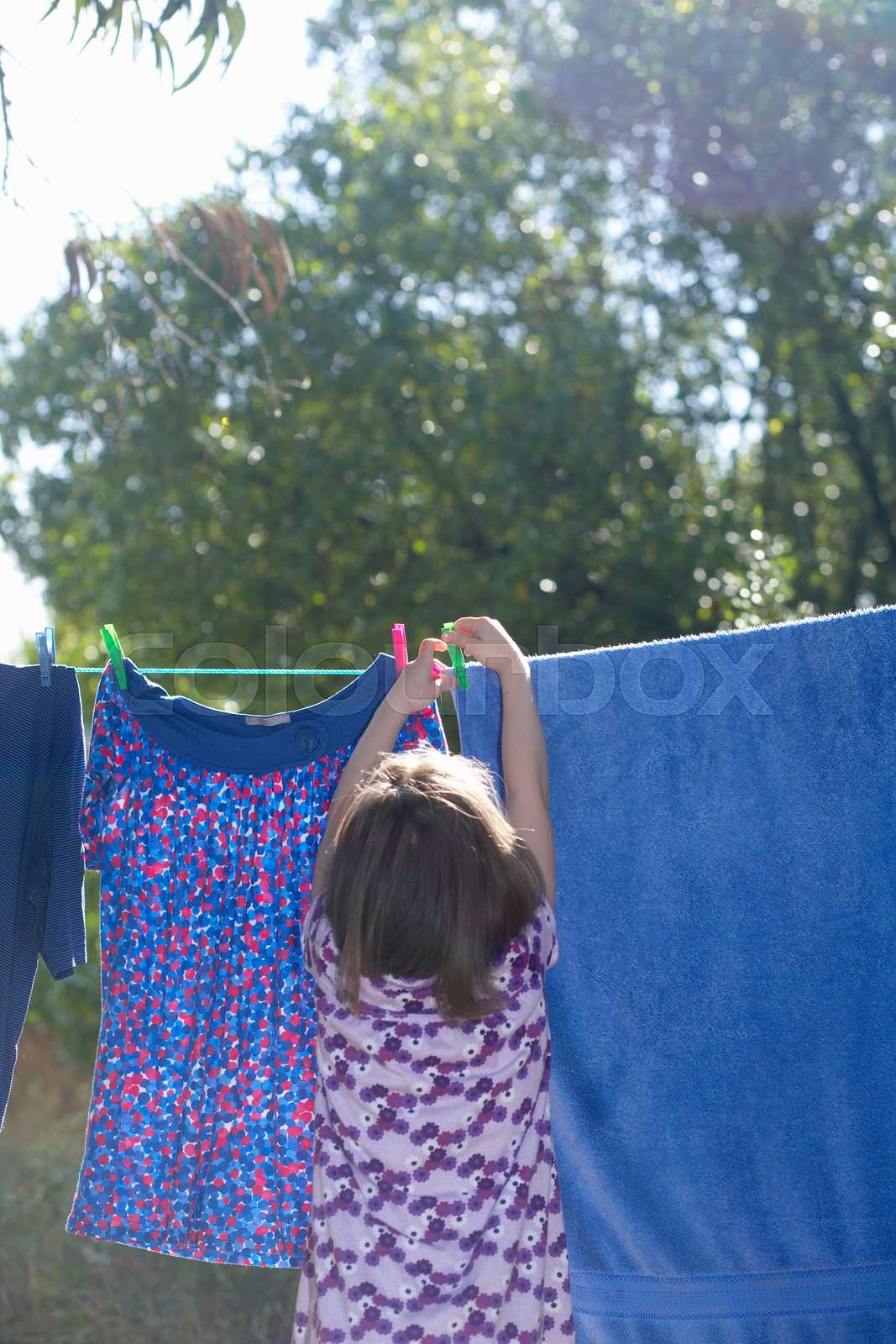 Young girl hanging washing | Stock image | Colourbox