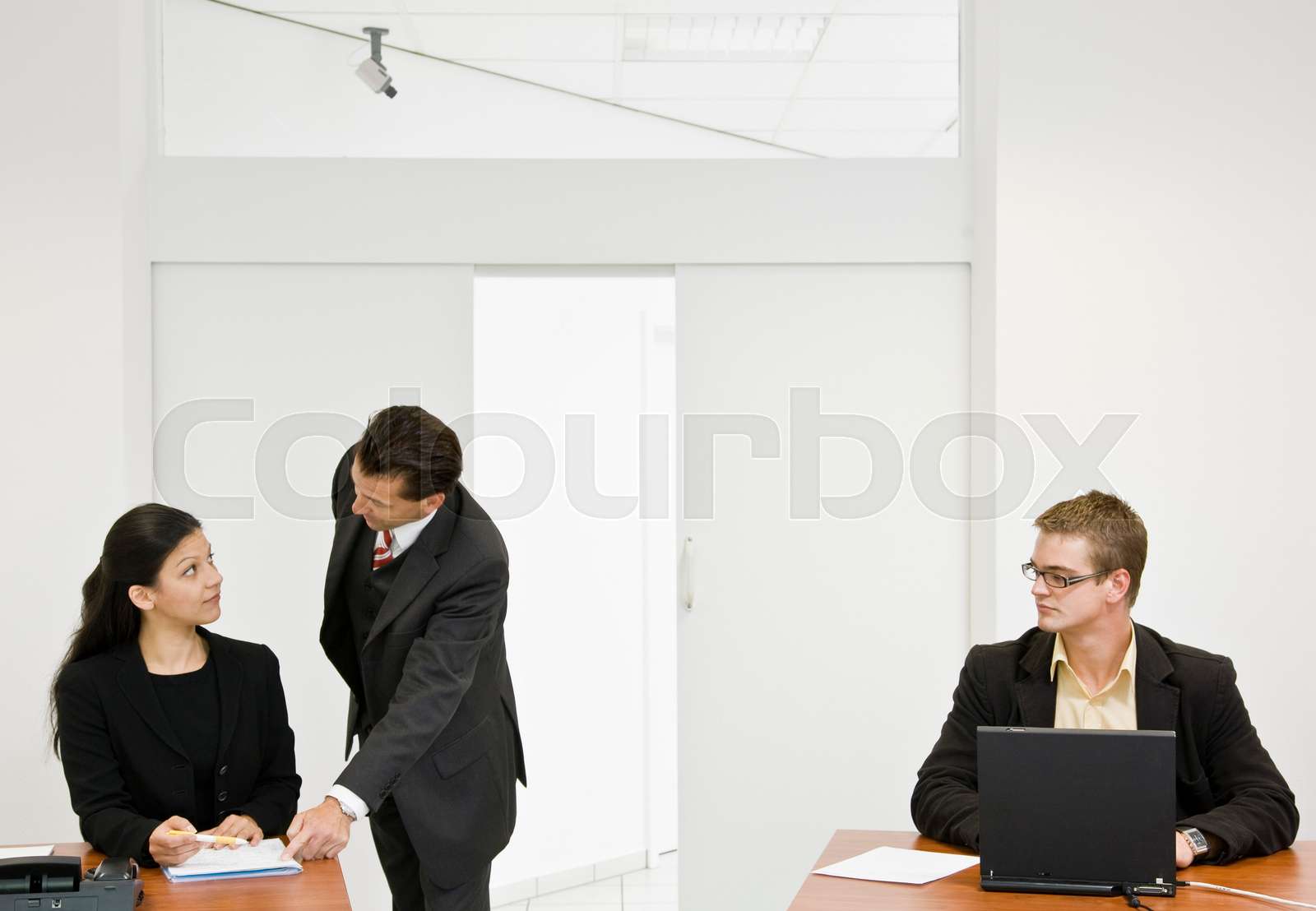 Boss helping co-workers | Stock image | Colourbox