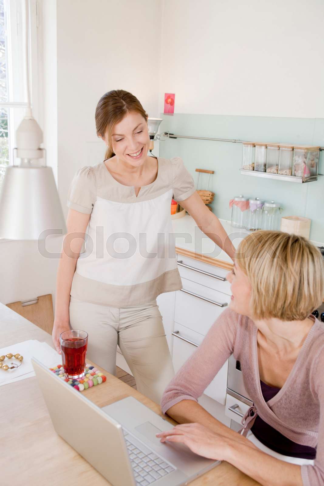 Women in kitchen talking | Stock image | Colourbox
