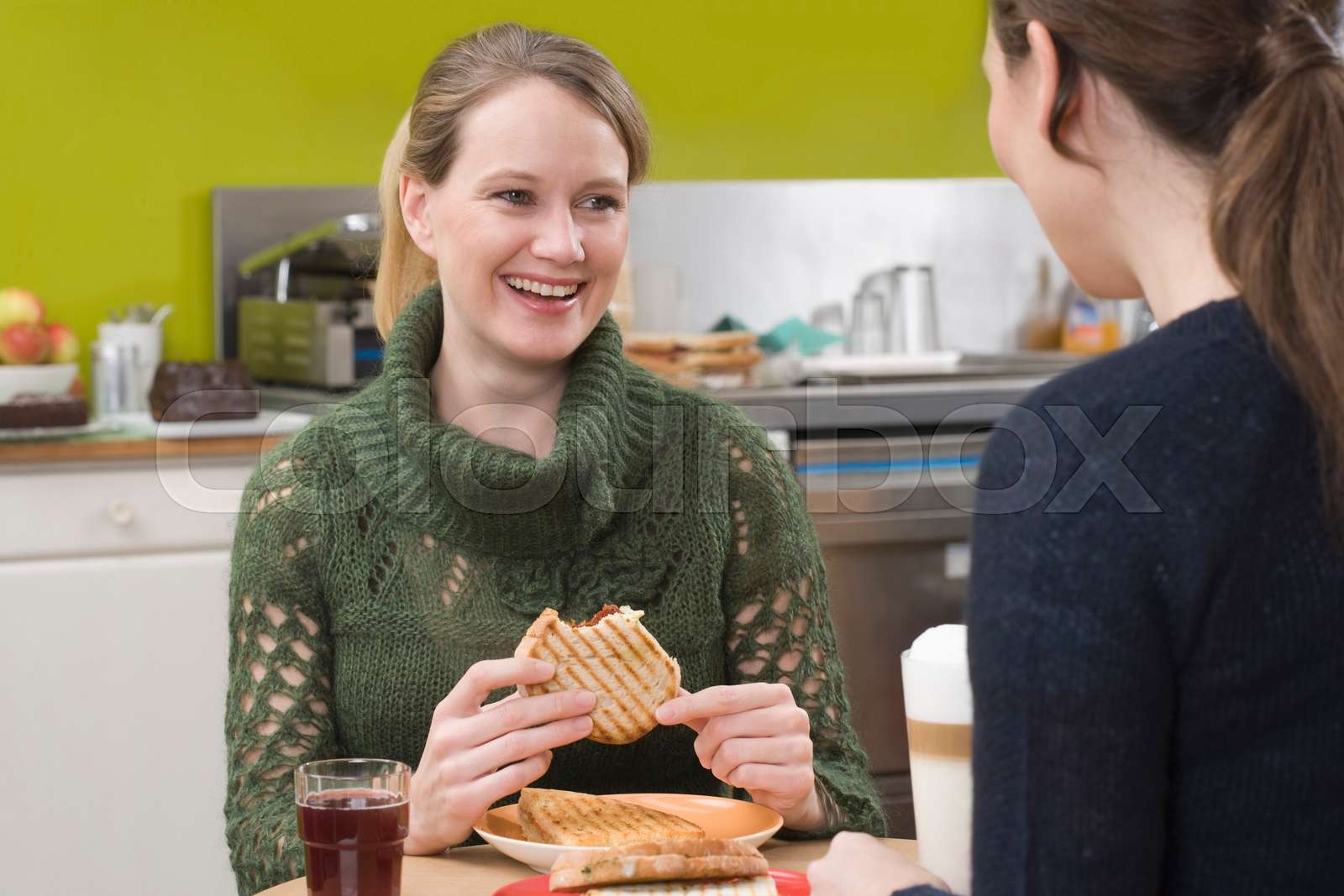 Two women in coffee shop, eating | Stock image | Colourbox