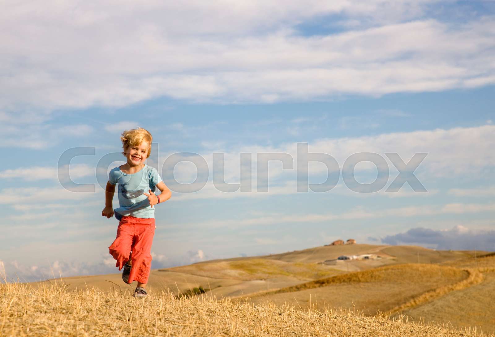 boy running across field | Stock image | Colourbox