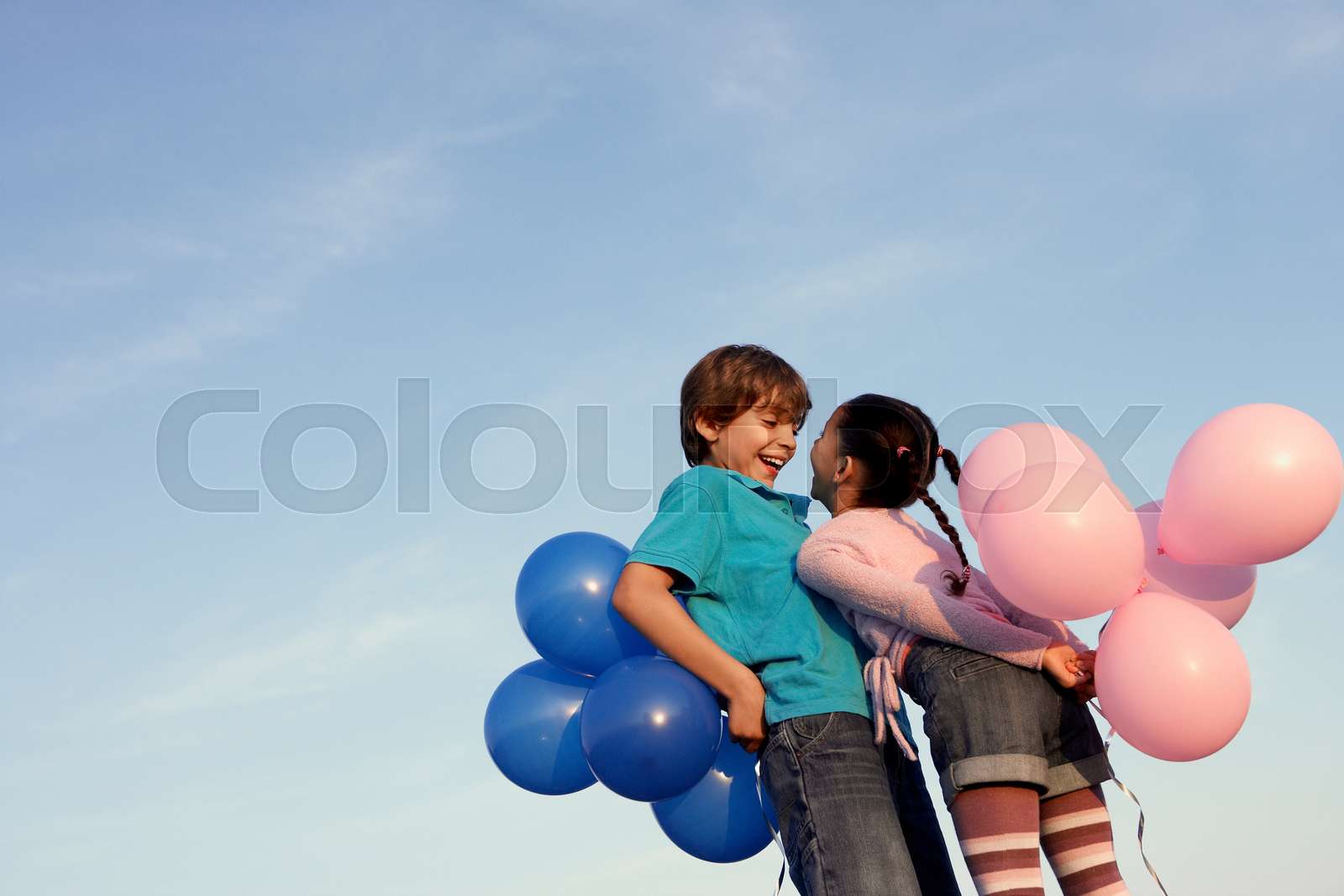 Kids laughing with balloons | Stock image | Colourbox