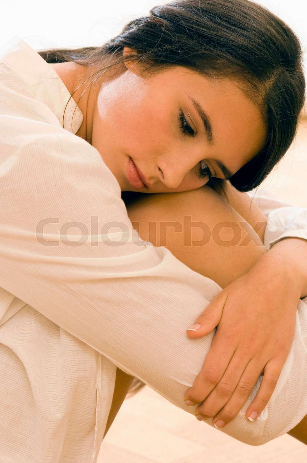 girl with arms around legs | Stock image | Colourbox