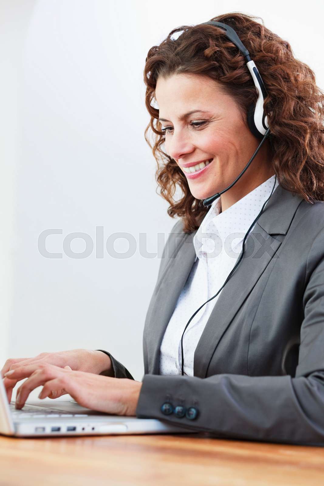 female call center agent typing | Stock image | Colourbox