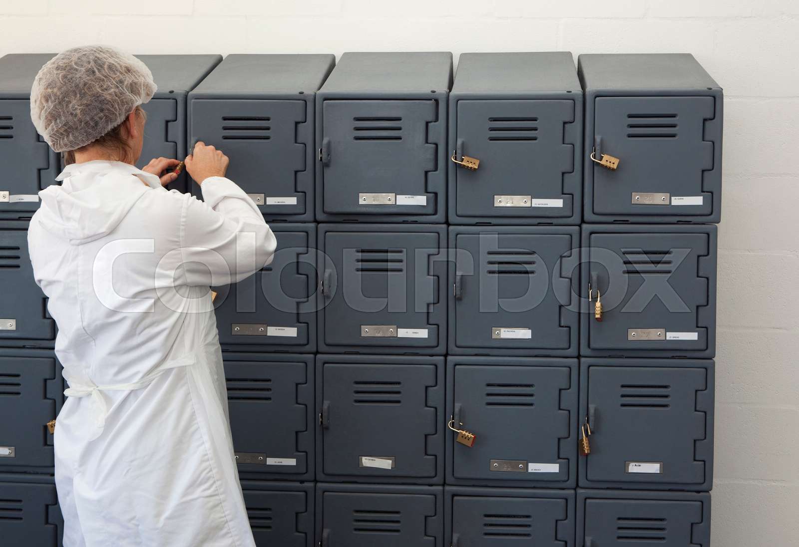 Factory worker opening locker | Stock image | Colourbox