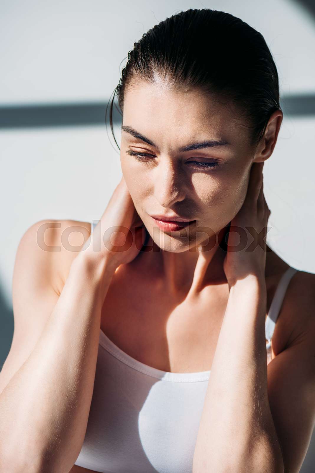 woman slicking back wet hair | Stock image | Colourbox