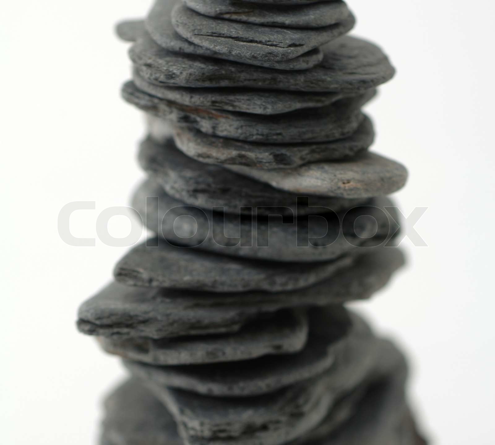 Stack of black stones balancing isolated on white | Stock image | Colourbox