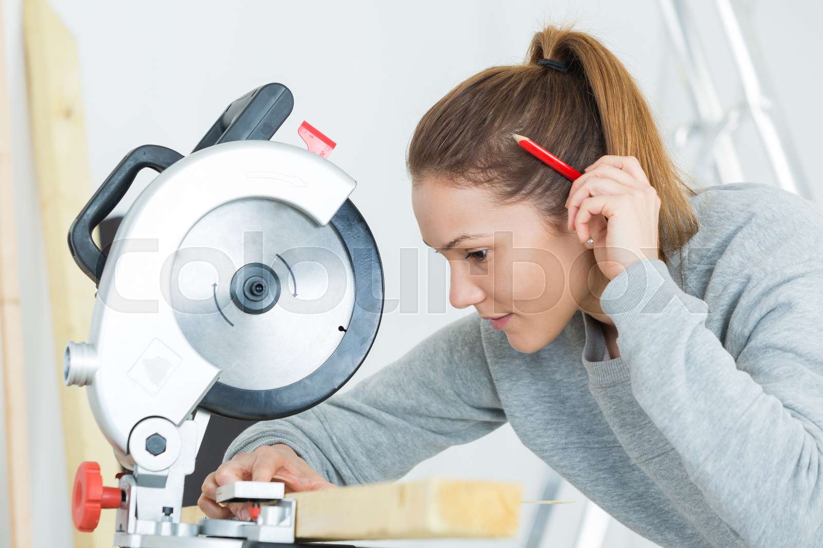 Carpenter putting pencil behind ear | Stock image | Colourbox