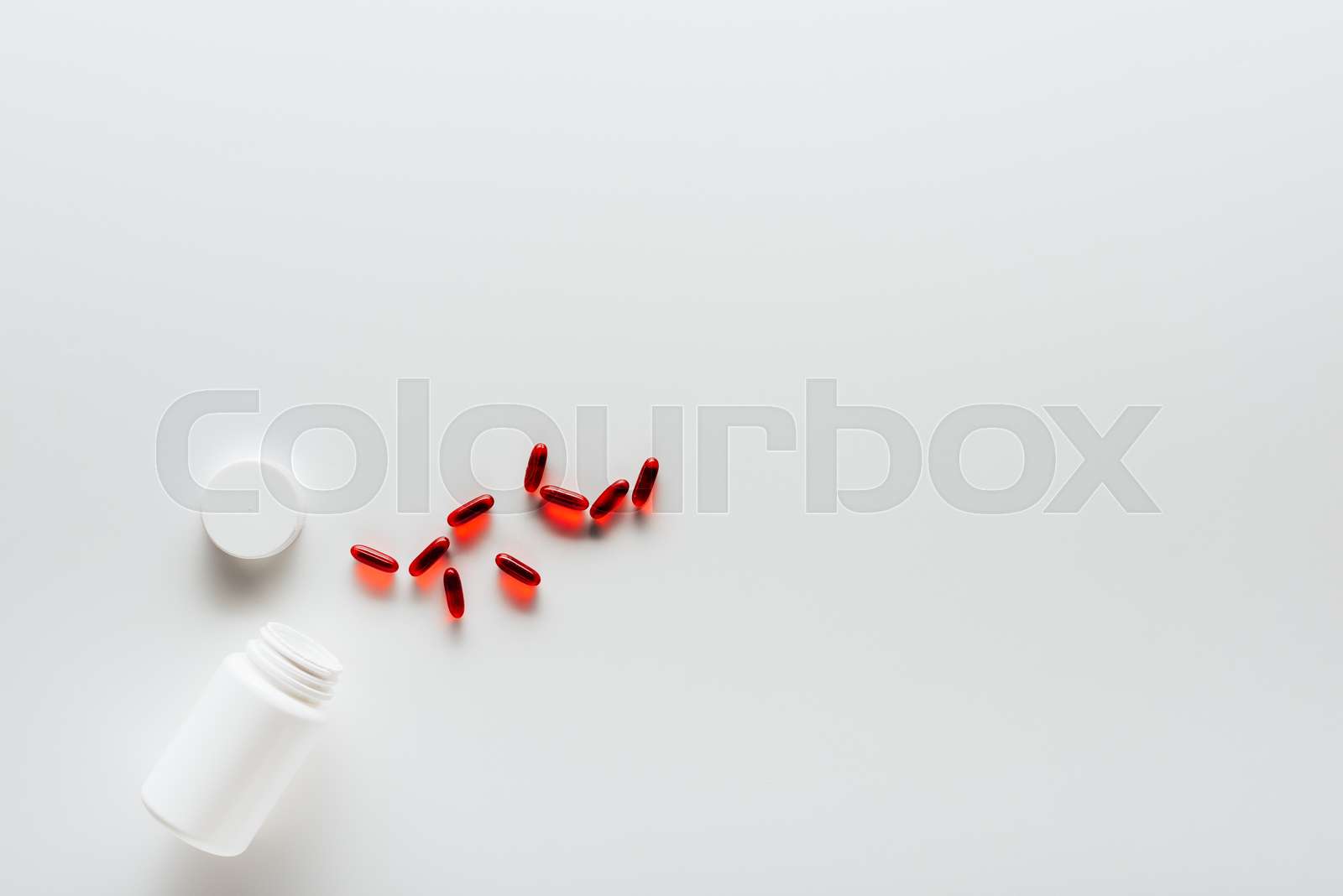 red capsules and container | Stock image | Colourbox