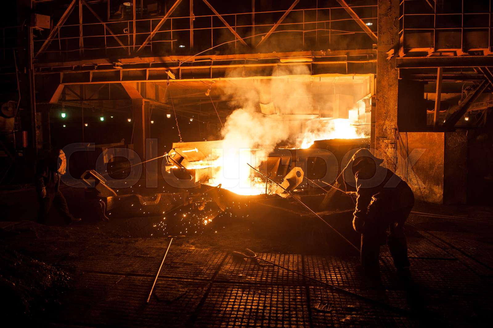 Steelworkers when pouring liquid titanium slag from arc furnace | Stock ...