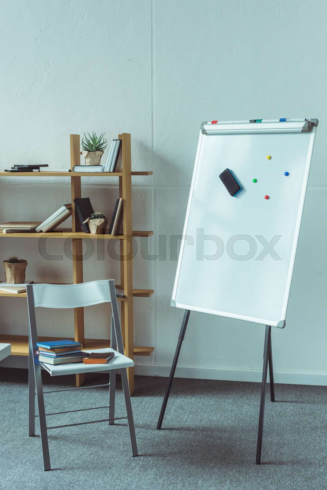 whiteboard and books on chair | Stock image | Colourbox
