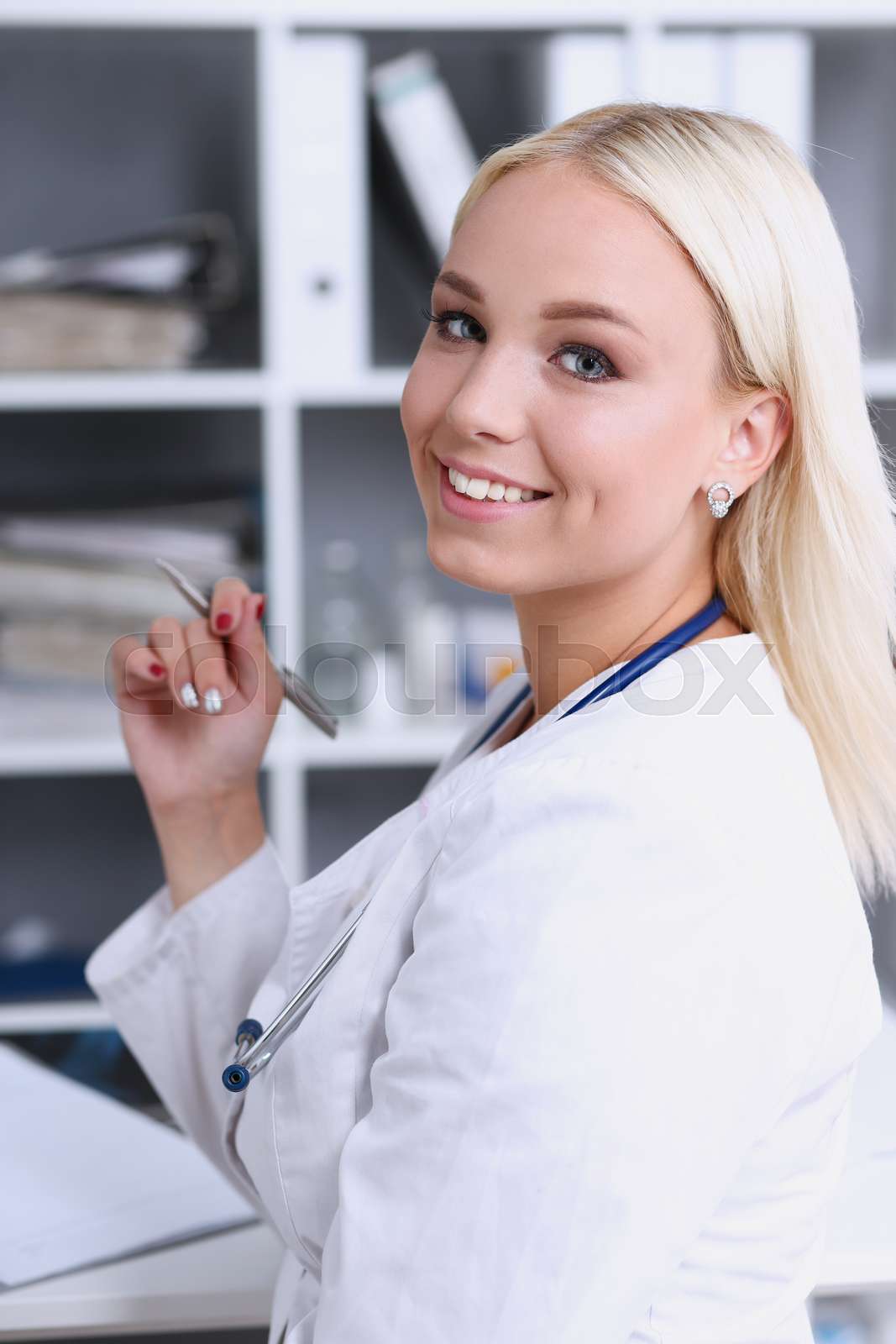 Beautiful smiling female doctor write prescription | Stock image ...