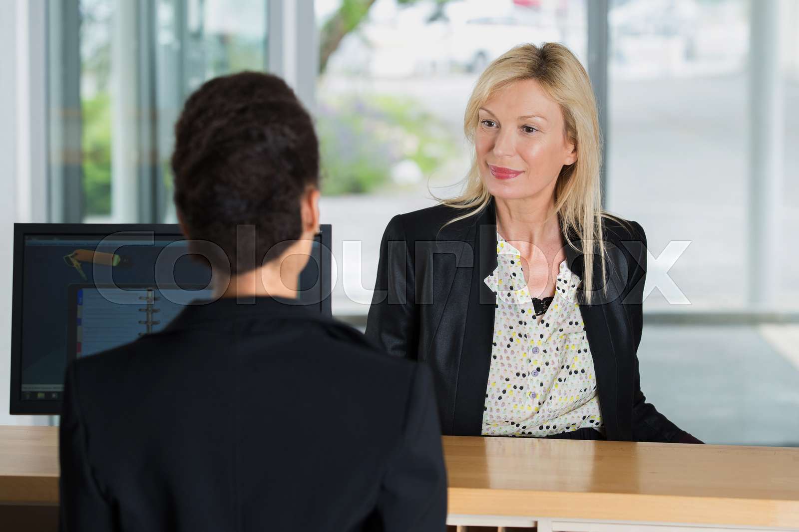 beautiful woman at the reception of a hotel checking in | Stock image ...