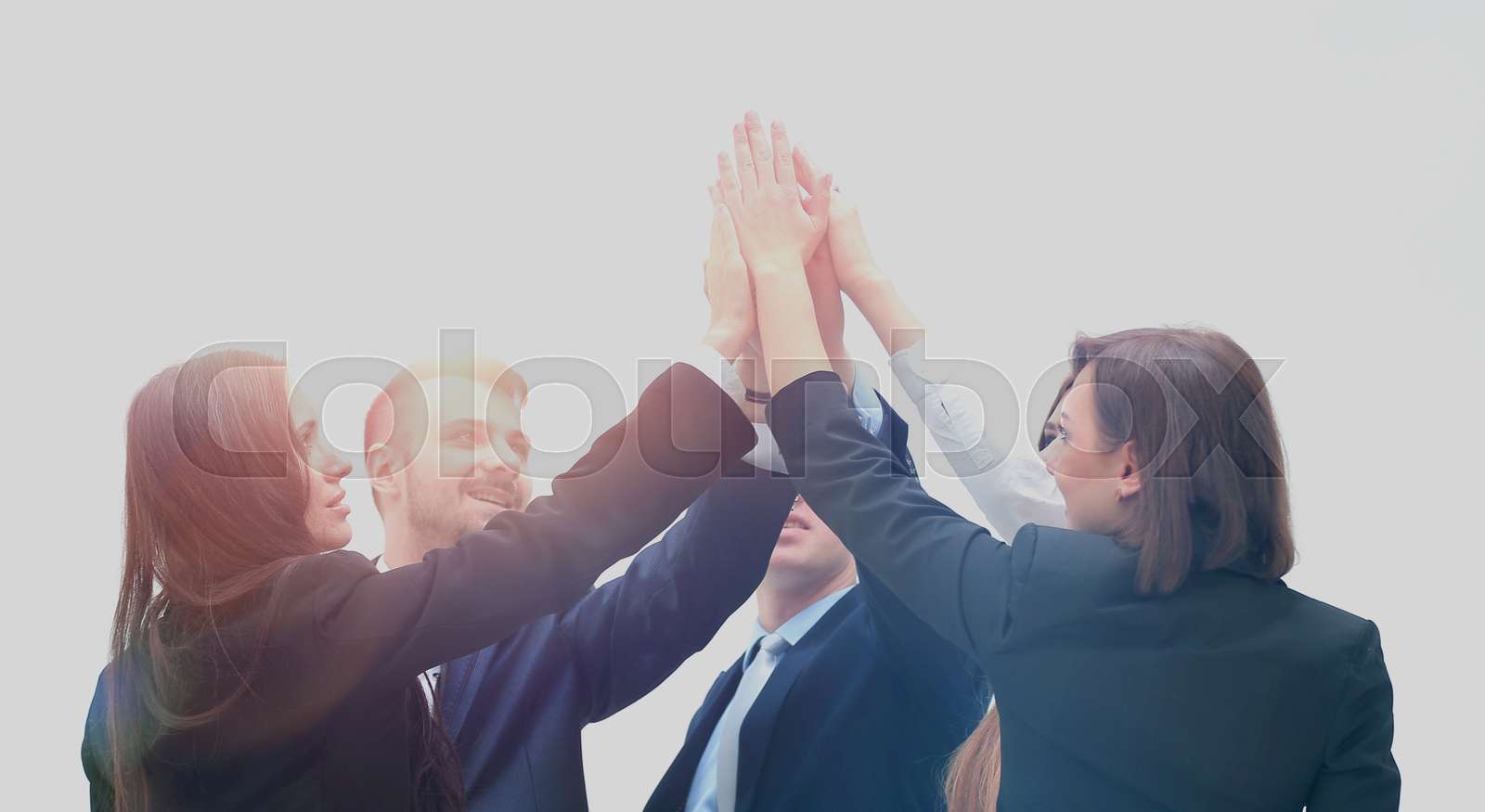 Group of business people celebrating their teamwork with a high five ...