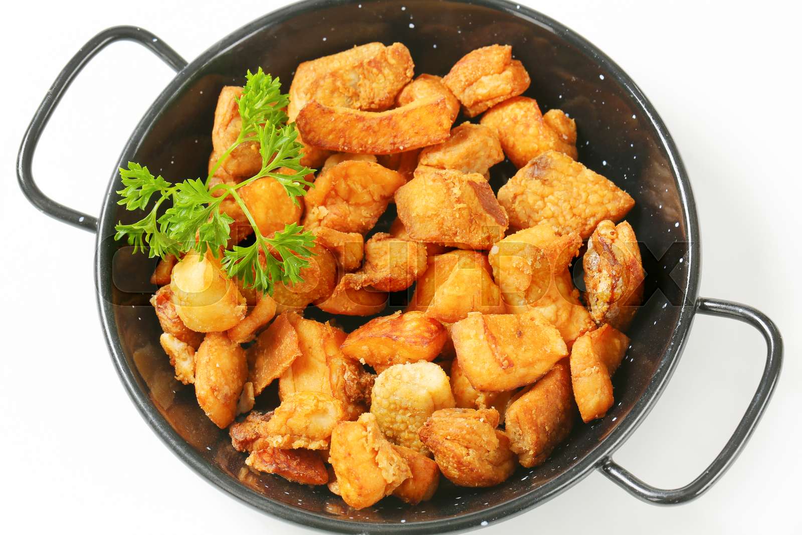Pork greaves in a skillet | Stock image | Colourbox