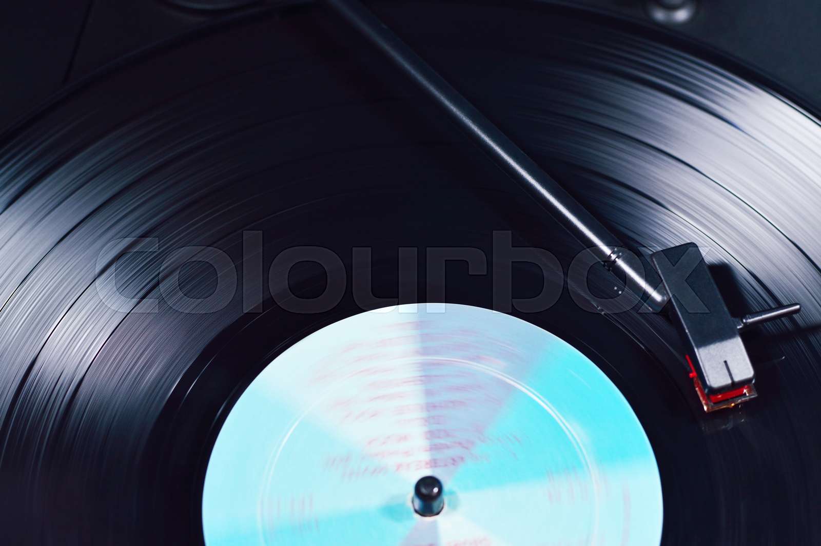 vinyl disc spinning on turntable with needle | Stock image | Colourbox