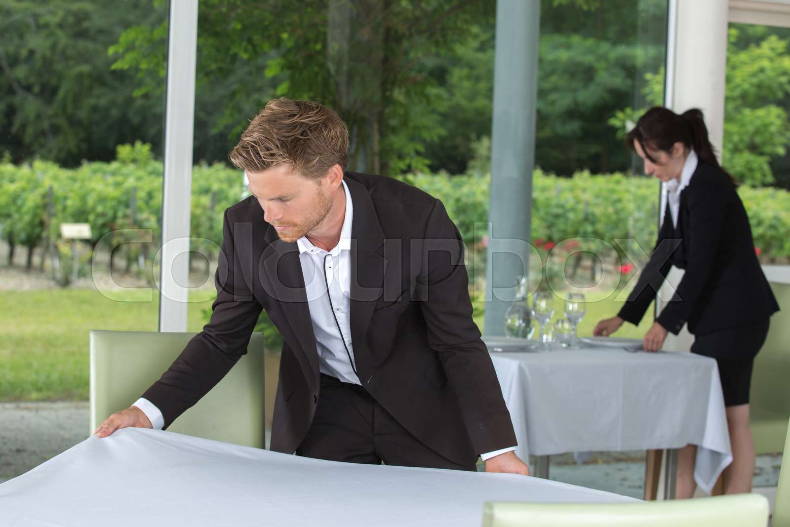 Waiting staff setting tables | Stock image | Colourbox