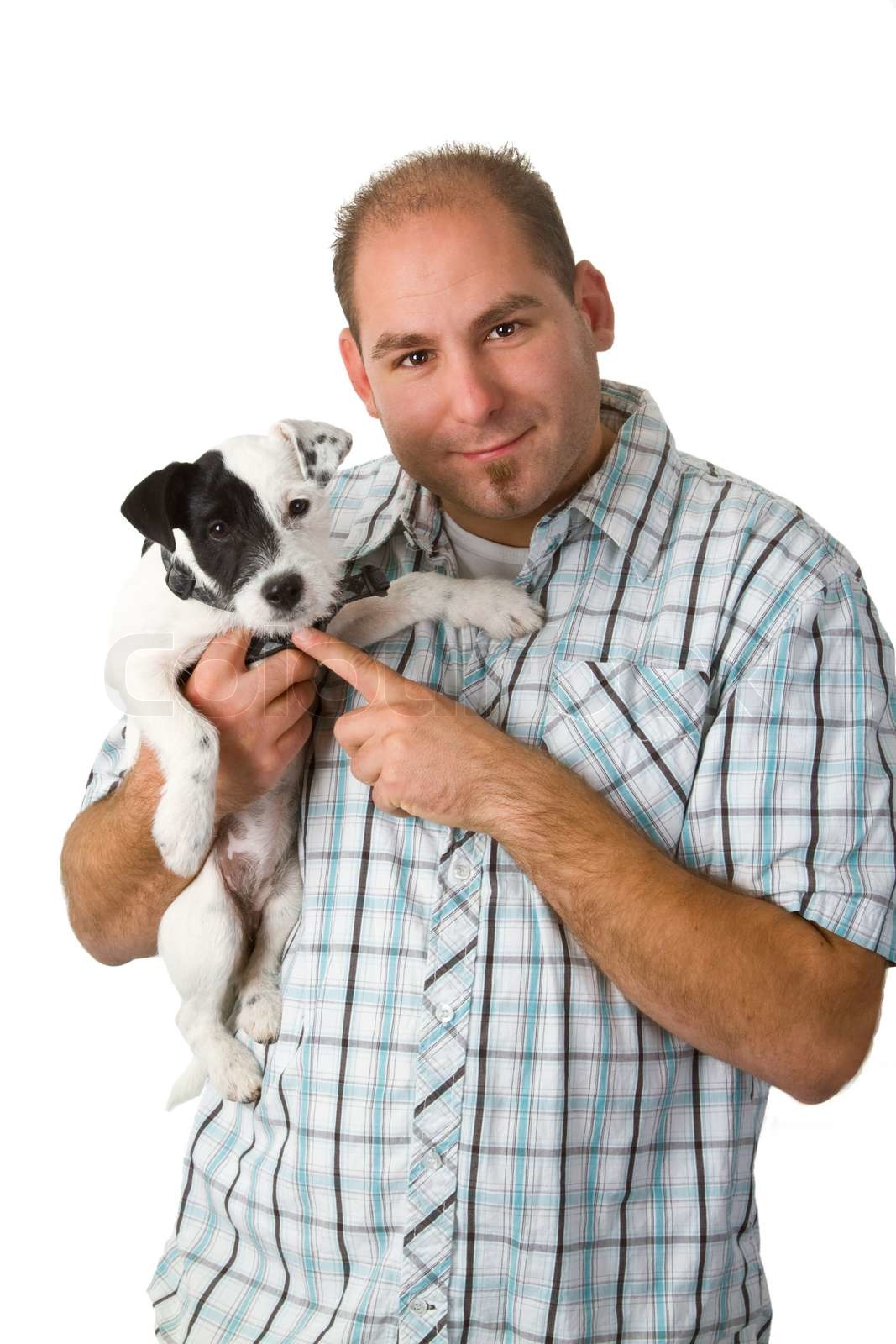 Young man is holding his sweet puppy isolated on white background ...