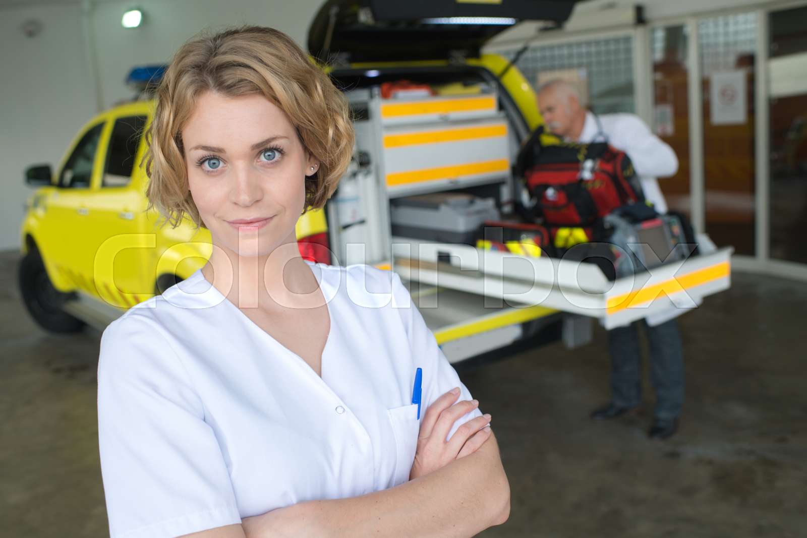nurse posing next to a medical car | Stock image | Colourbox