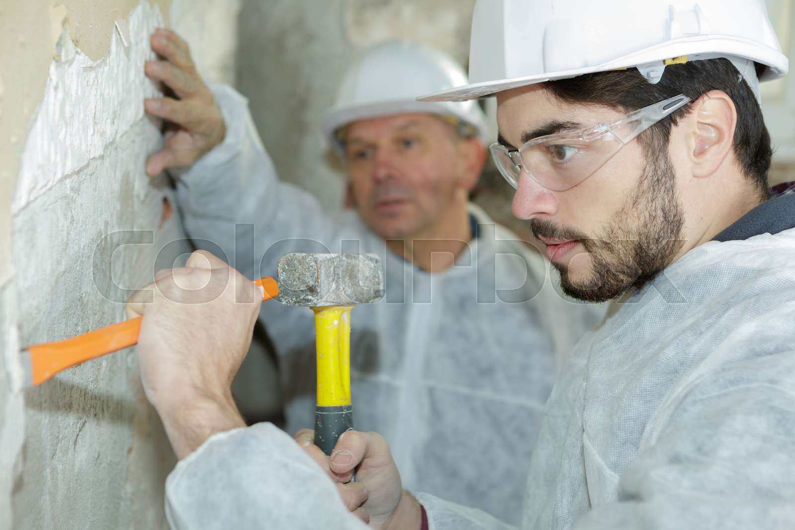 builders on wall demolition | Stock image | Colourbox