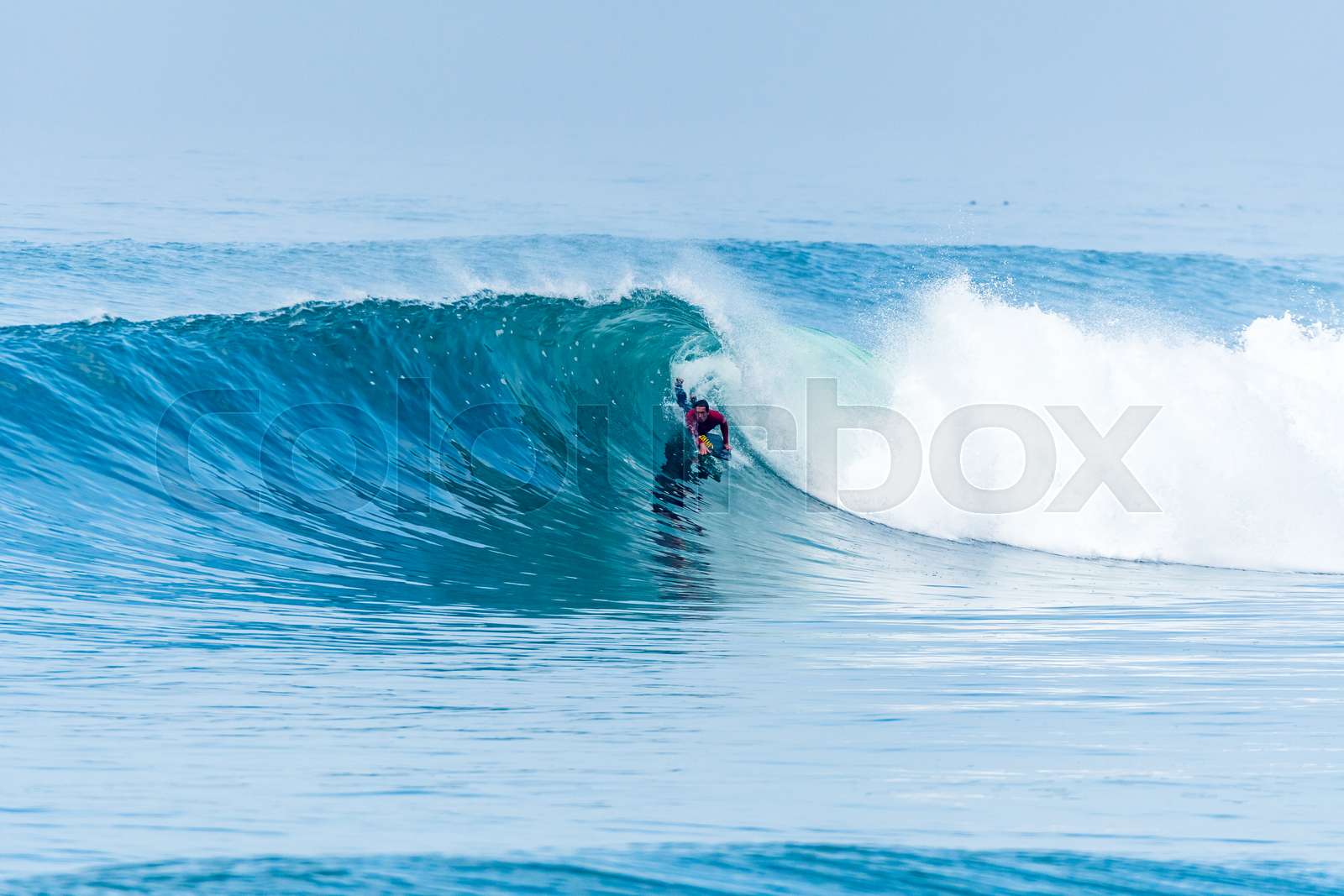 Bodyboarder surfing ocean wave | Stock image | Colourbox