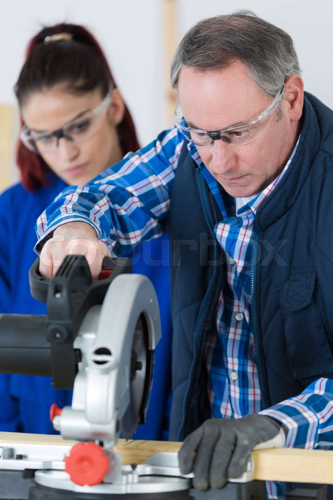 student and teacher in carpentry class using circular saw | Stock image ...