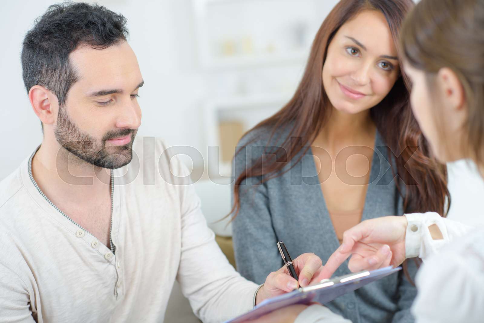 couple at home signing paper | Stock image | Colourbox