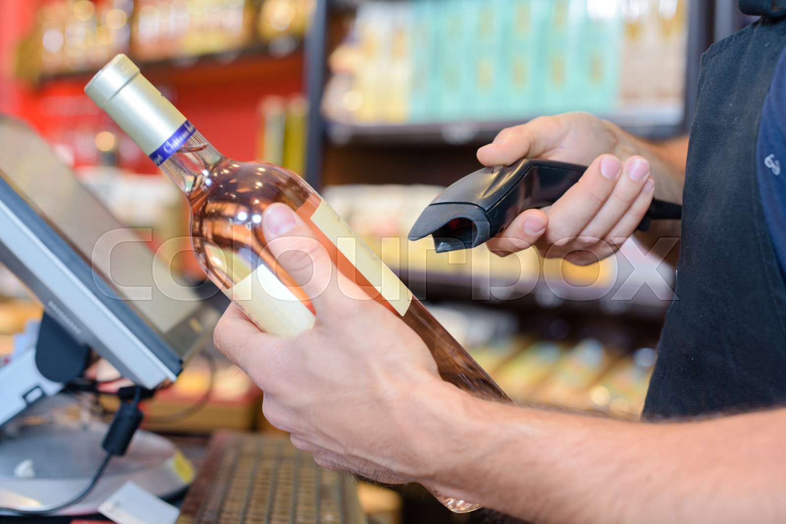 scanning a bottle of liquor | Stock image | Colourbox