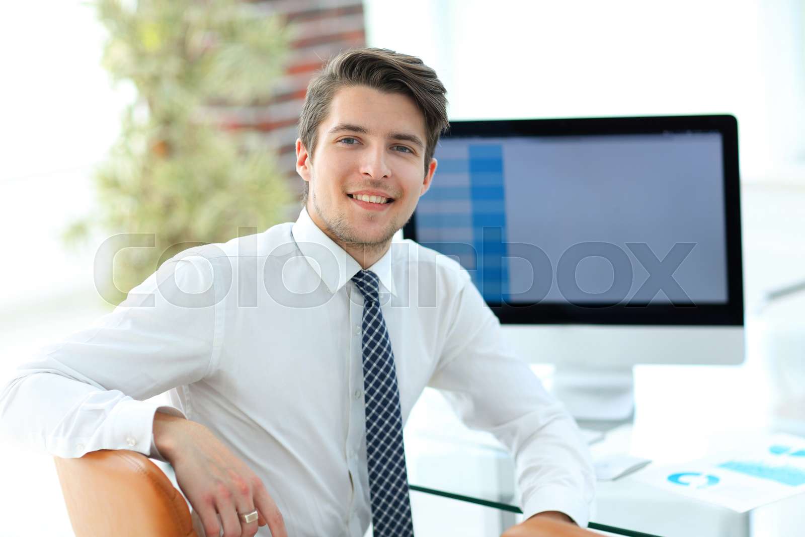 employee sitting in front of a computer screen | Stock image | Colourbox