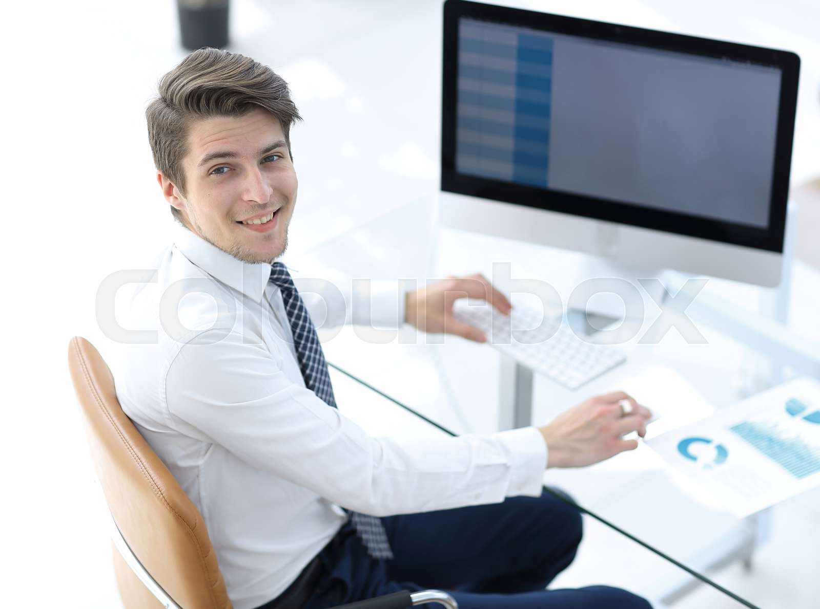 employee sitting in front of a computer screen | Stock image | Colourbox