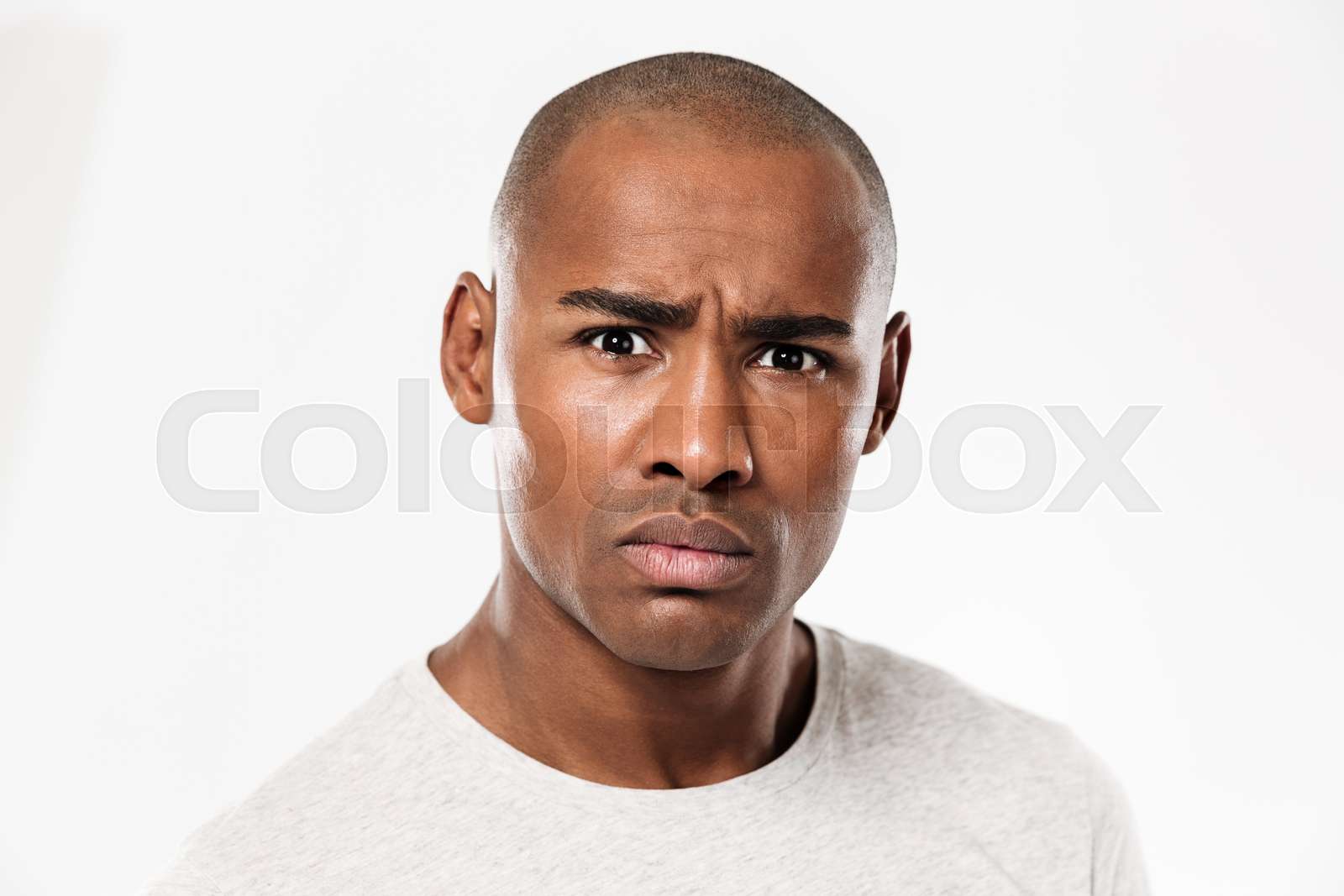 Confused young african man standing isolated | Stock image | Colourbox