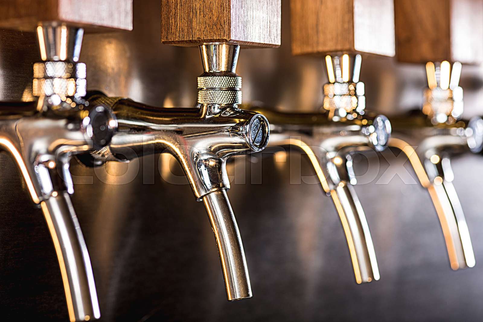 Beer taps in a pub | Stock image | Colourbox